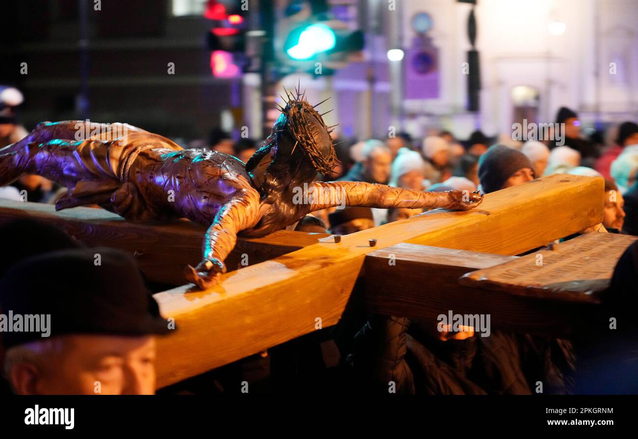 Worshippers hold a cross during a Way of the Cross procession in ...