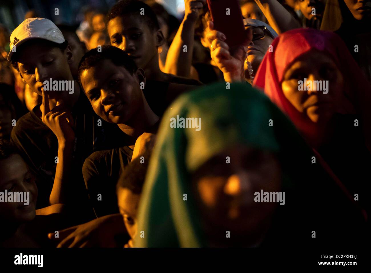 Residents watch a Way of the Cross reenactment at the Complexo do ...