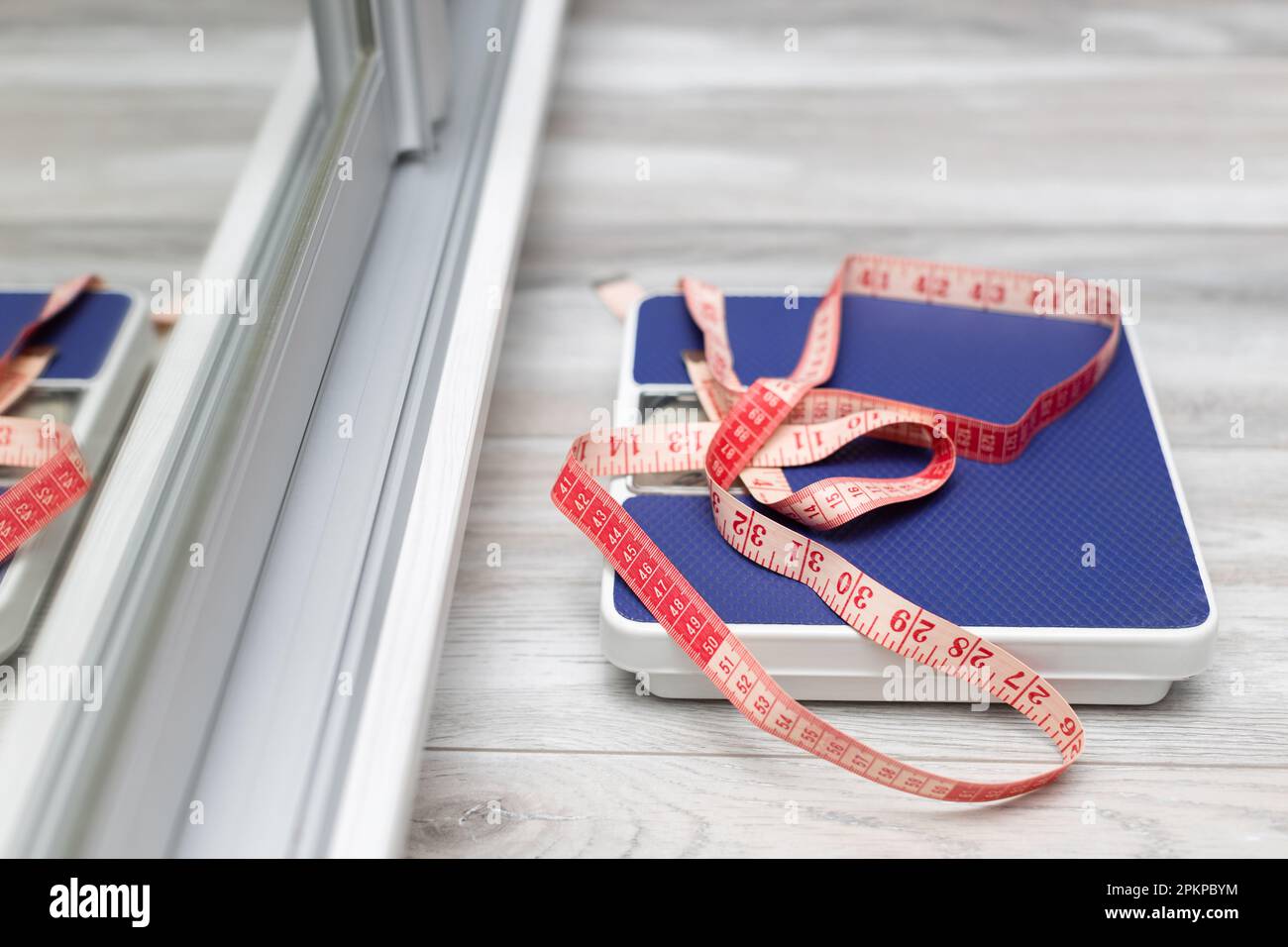 Rotes Maßband mit geringer Schärfentiefe. Rotes Maßband liegt auf der ...