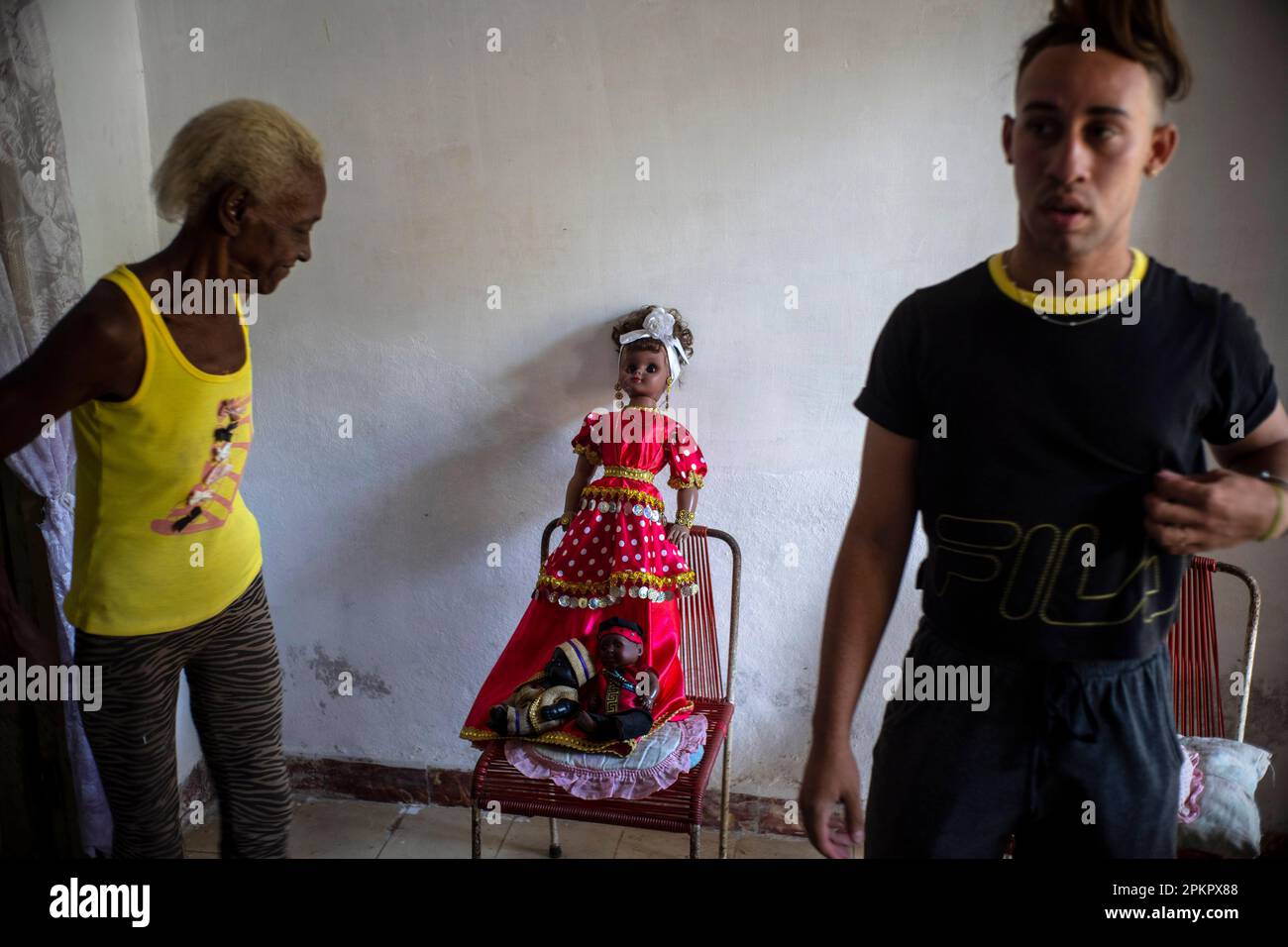 A doll depicting the Yoruba deity Yemayá is propped up on a chair ...