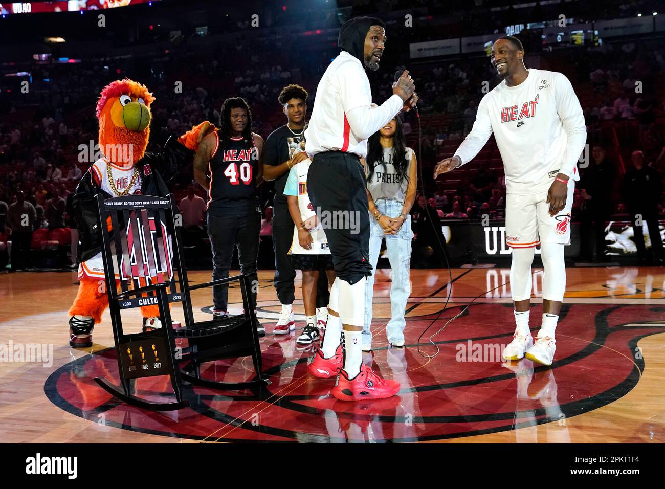 Miami Heat forward Udonis Haslem, left, stands with center Bam Adebayo, right, as he is ...