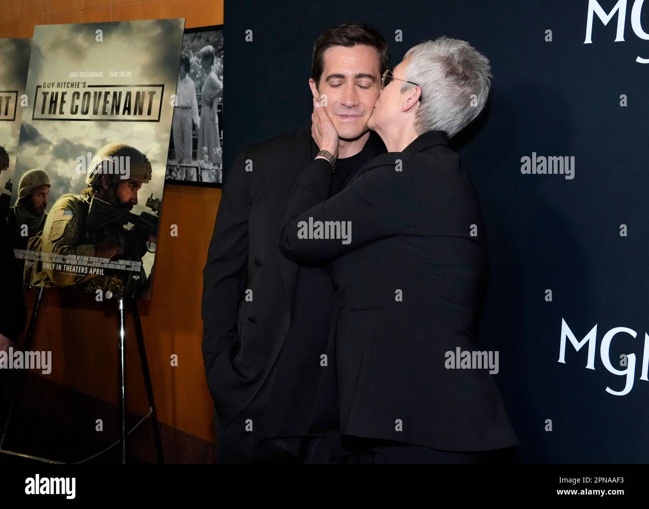 Jake Gyllenhaal, left, a cast member in "The Covenant," gets a kiss ...