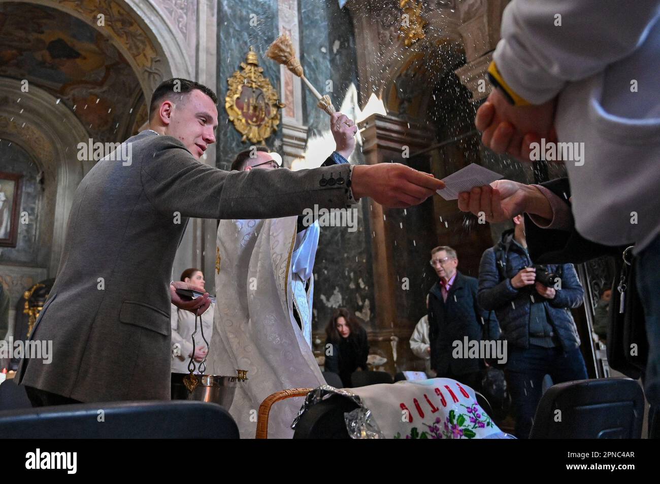 LEMBERG, UKRAINE - 15. APRIL 2023 - Ein Priester segnet die Gläubigen ...