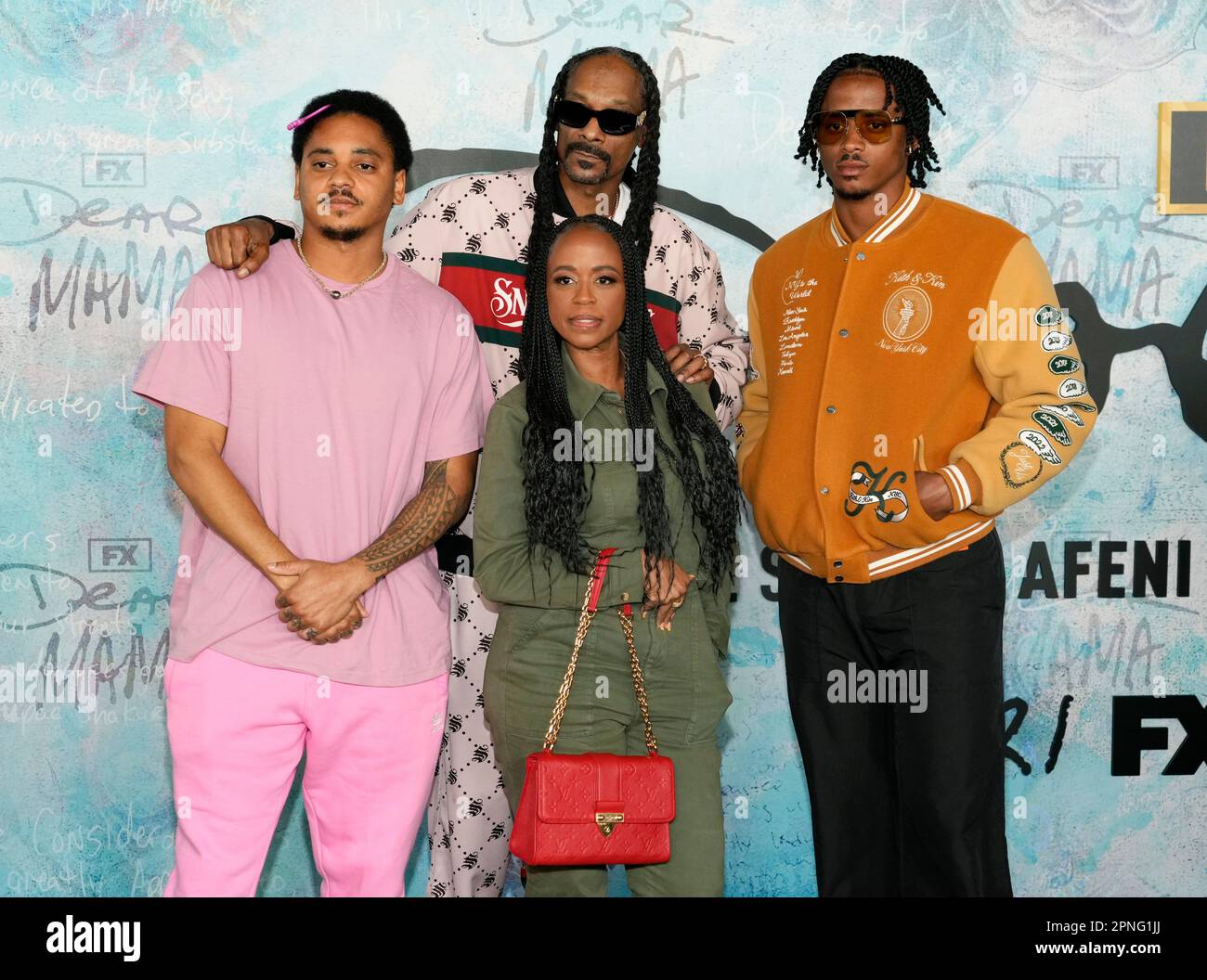 Rapper Snoop Dogg, top center, poses with his wife Shante Broadus and ...