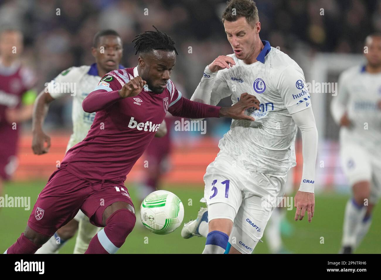 West Ham's Maxwel Cornet, left, challenges for the ball with Gent's ...