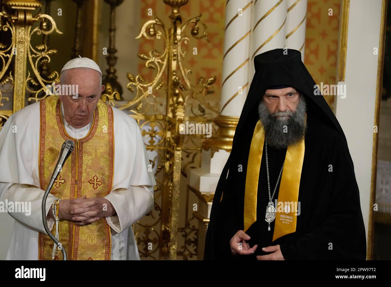 Pope Francis, left, is welcomed by by Archbishop Peter Fulop Kocsis ...