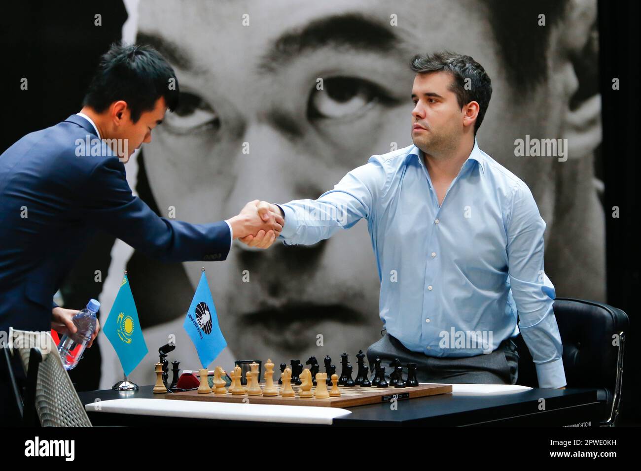 Russia's Ian Nepomniachtchi, right, and China's Ding Liren shake hands ...