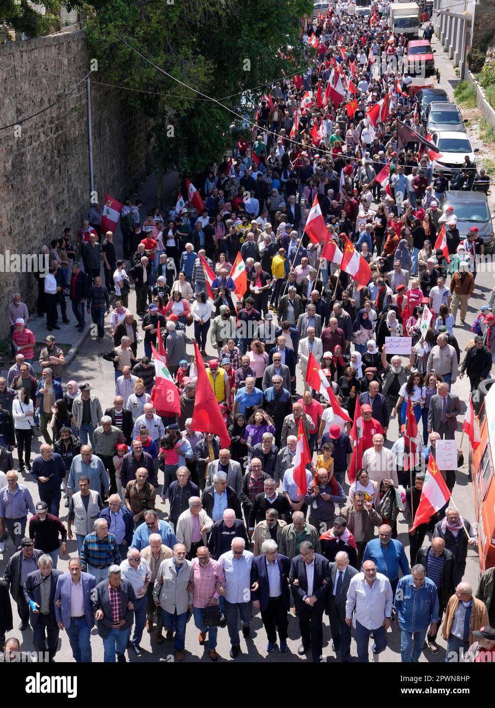 Members of the Lebanese Communist Party holding party flags gather ...