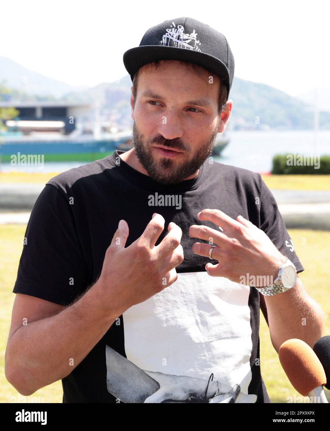 French artist Saype is interviewed at Onoue no Oka, a disaster ...