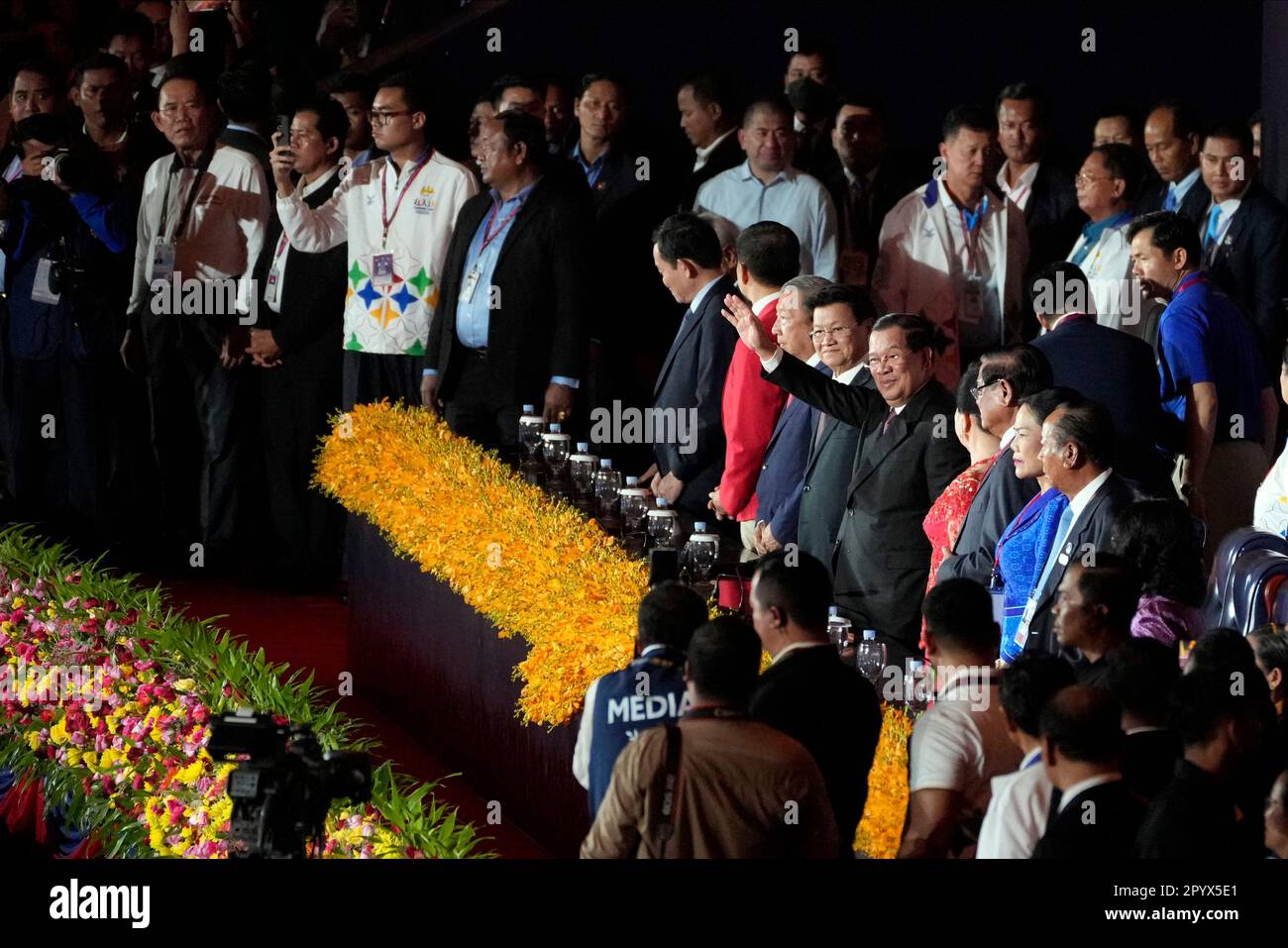 Cambodian Prime Minister Hun Sen, center right, waves to the crowd as ...