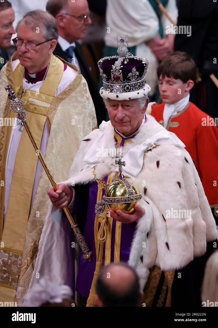 Britain's King Charles III wears the Imperial State Crown and holds the Sovreign's Orb and ...