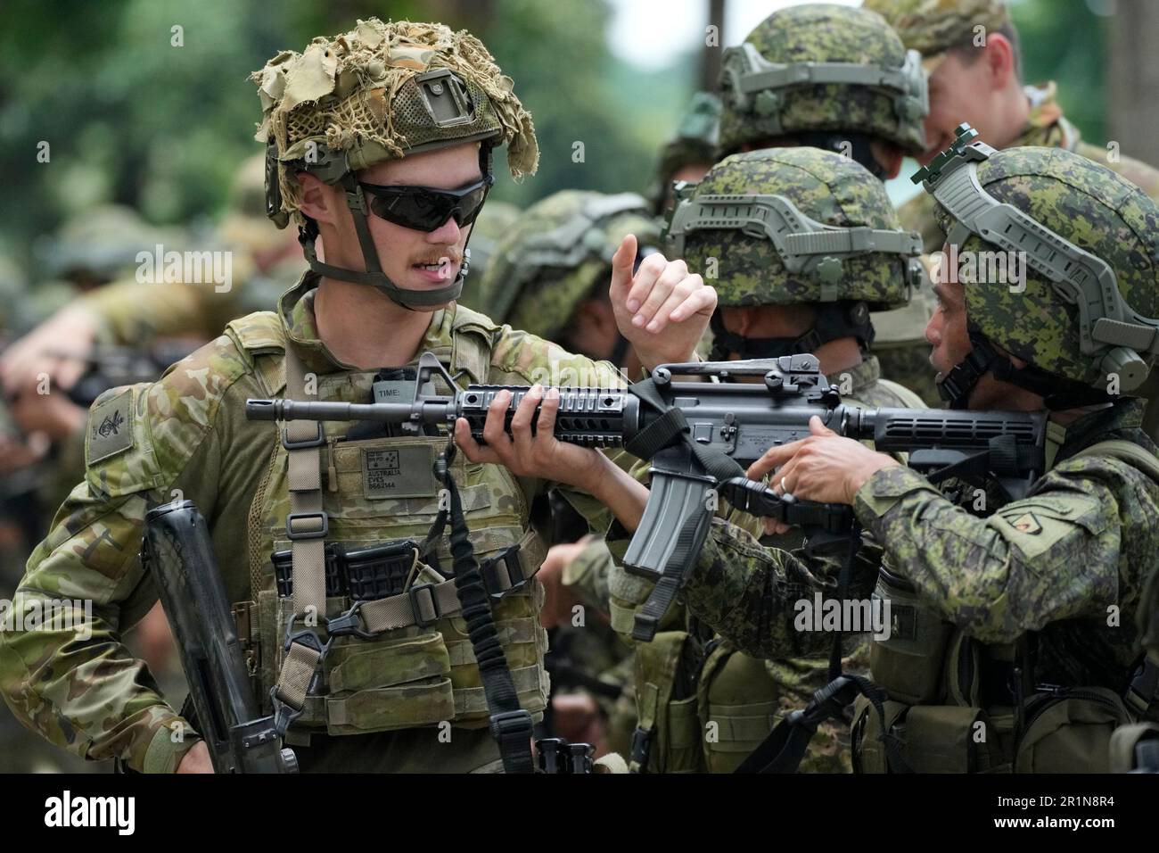 An Australian trooper, left, instructs a Philippine soldier in close ...