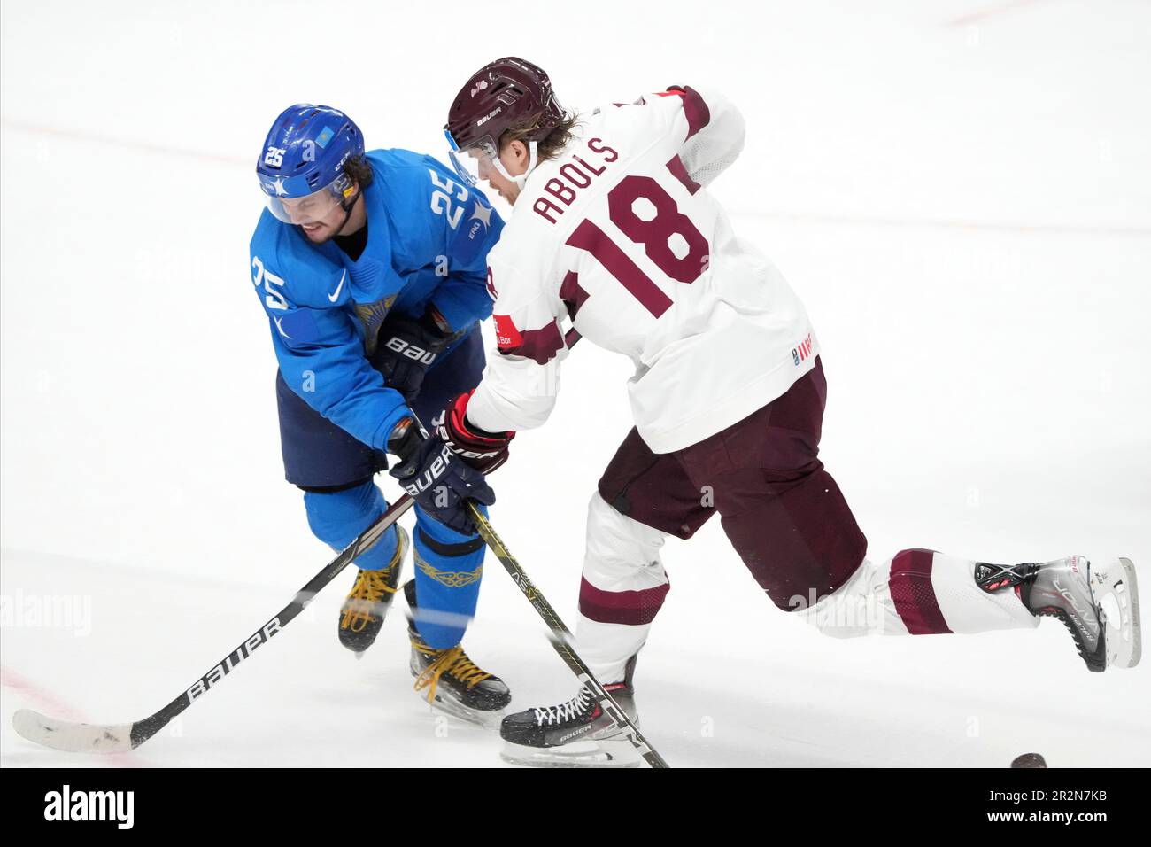 Rodrigo Abols of Latvia, right, fights for a puck with Danil Butenko of ...