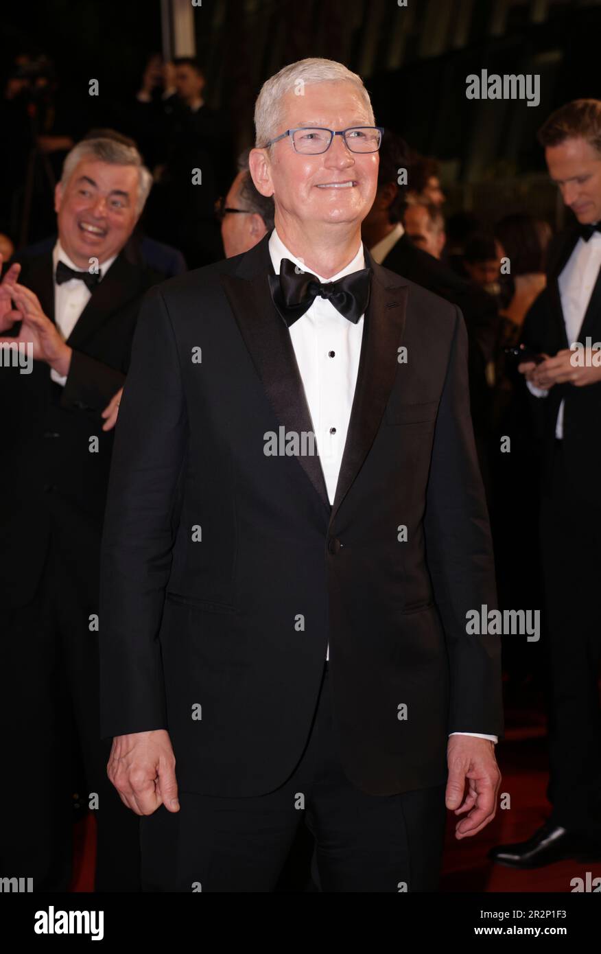 Tim Cook poses for photographers upon departure from the premiere of ...