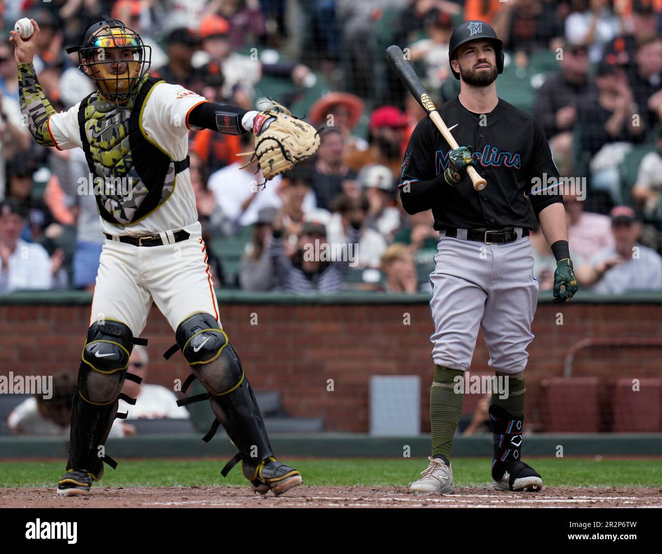 Miami Marlins' Jon Berti, right, reacts next to San Francisco Giants ...