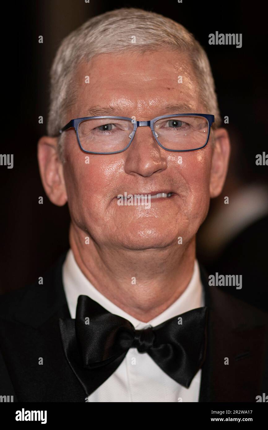 Tim Cook poses for photographers upon departure from the premiere of ...