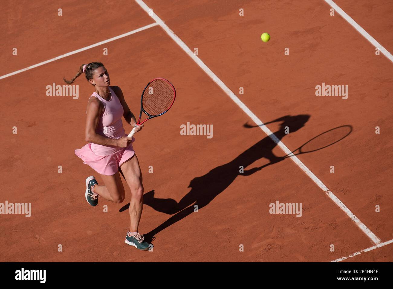 Italy's Camilla Giorgi runs to play a shot against France's Alize ...