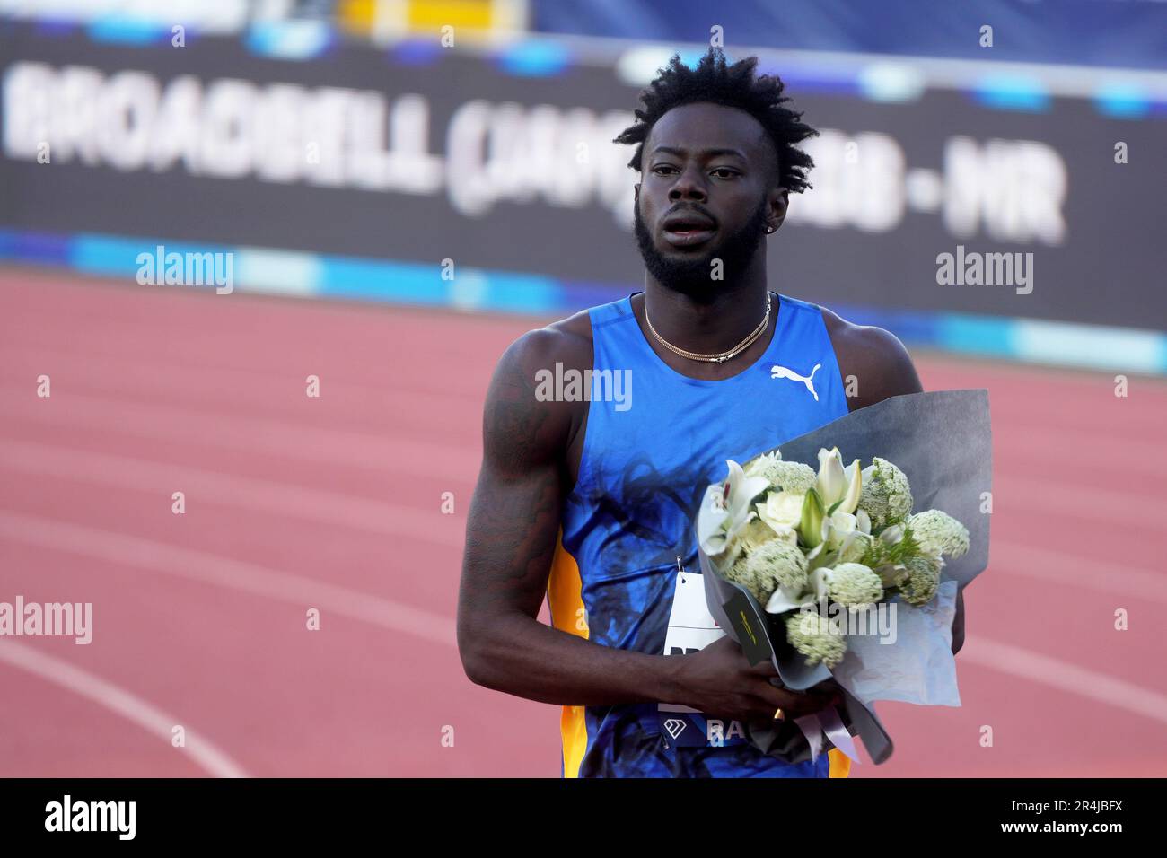 Rasheed Broadbell, of Jamaica, holds flowers after winning the Men 110 ...