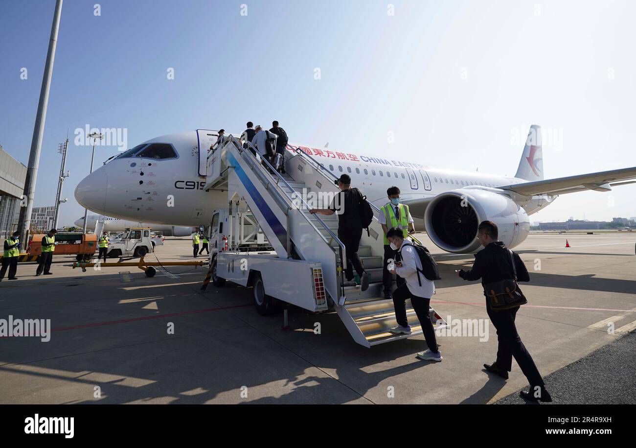 Passengers get on board C919 aircraft of China Eastern Airline which will make its first regular ...