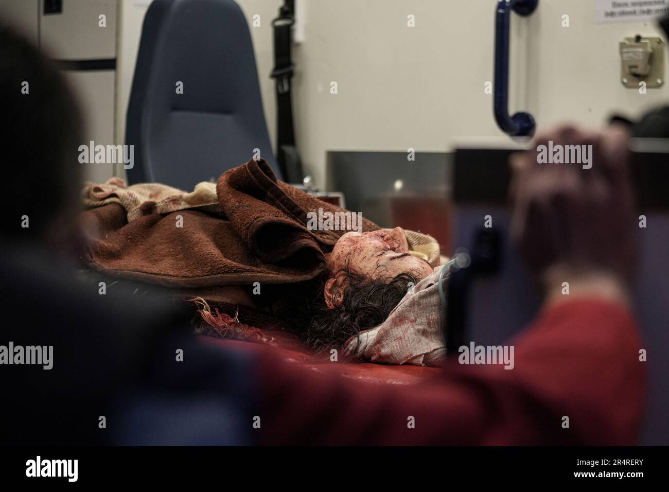 The body of a woman is laid out in an ambulance after she was killed in ...