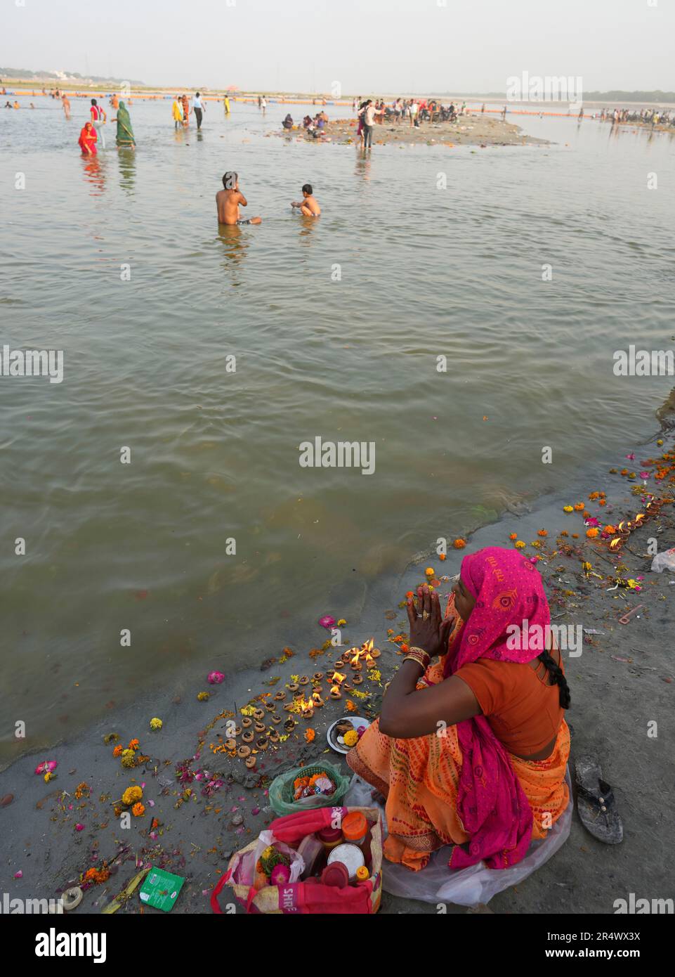 A devotee performs rituals by the banks of the River Ganges on Ganga ...