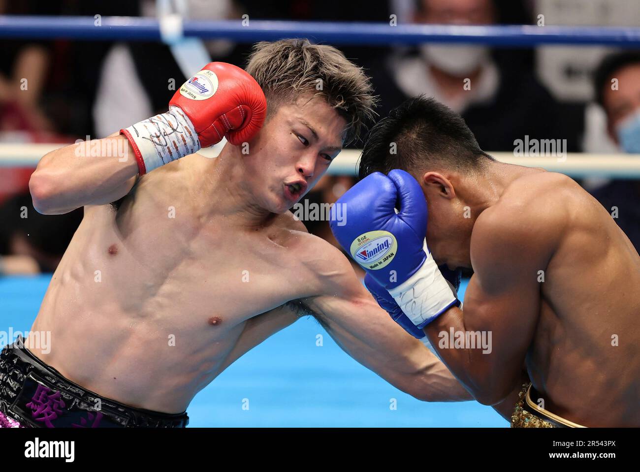 Hayato Tsutsumi of Japan (L) punches Joe Santisima of Philippines ...