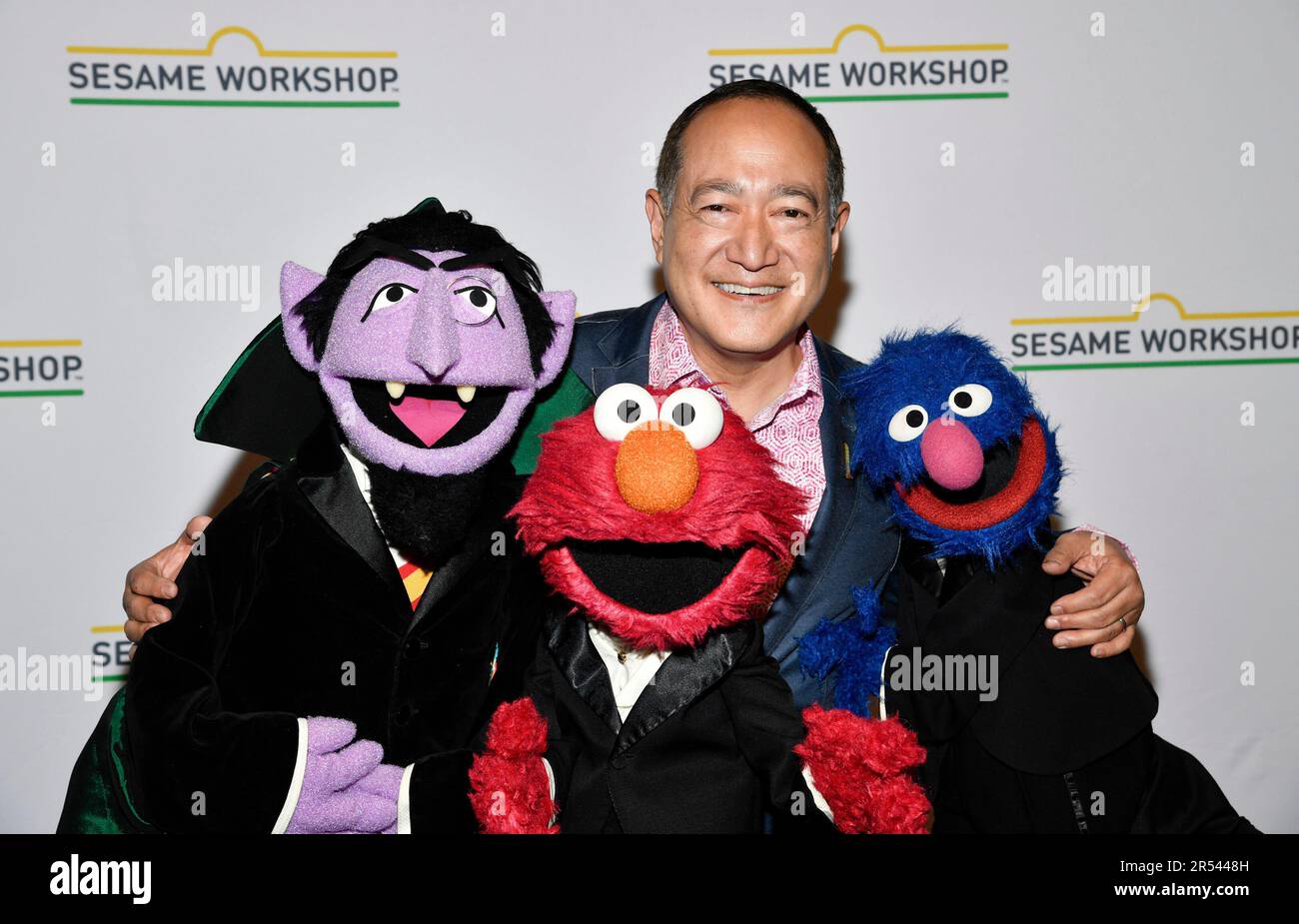 Actor Alan Muraoka, center, poses with Count von Count, Elmo and Grover at the Sesame Workshop ...