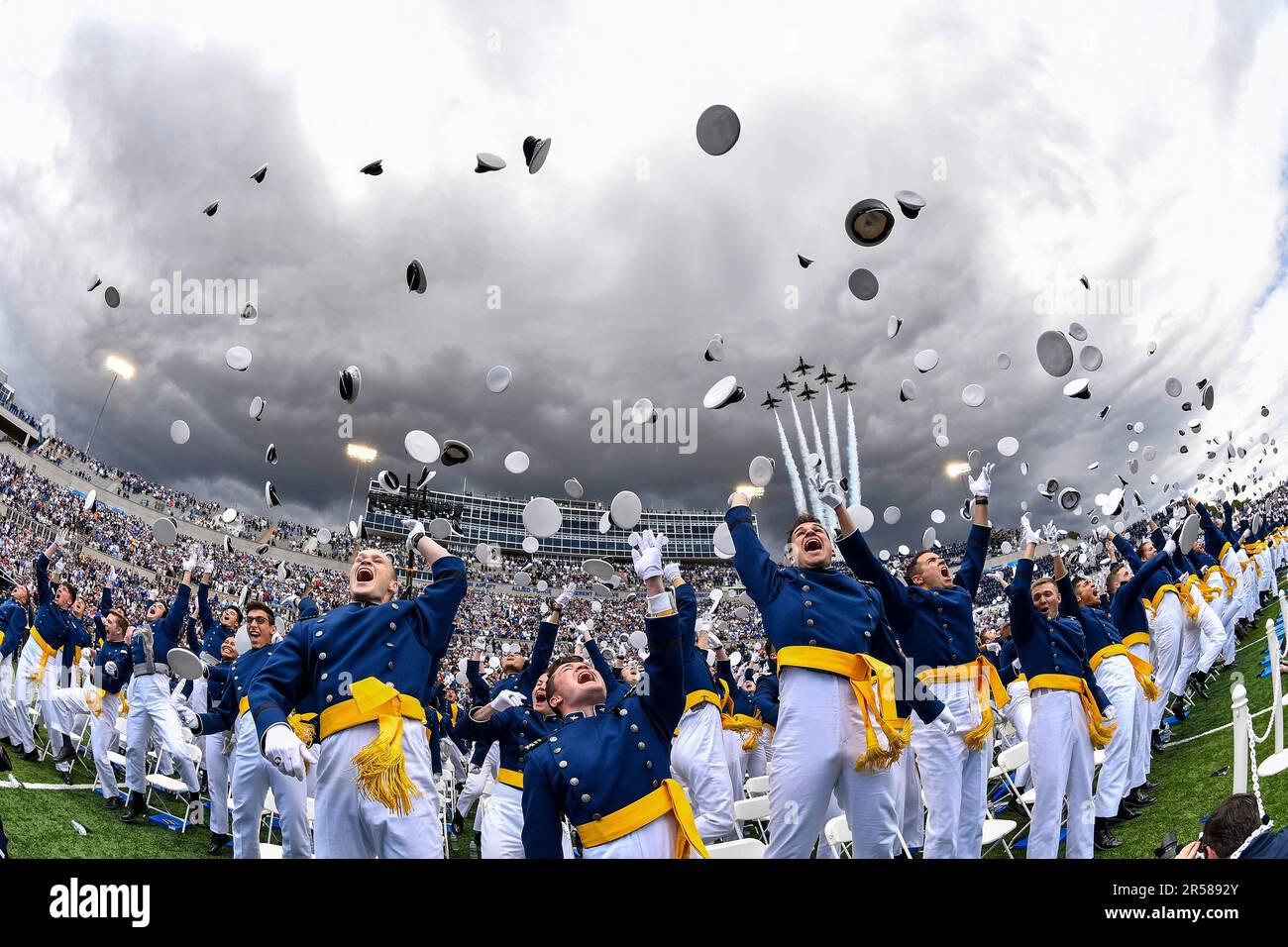 Air Force Cadets toss their caps in the air as the Thunderbirds fly ...