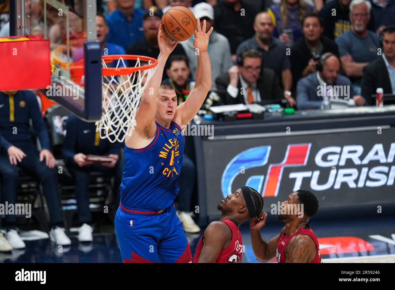 Denver Nuggets center Nikola Jokic, left, passes the ball next to Miami ...