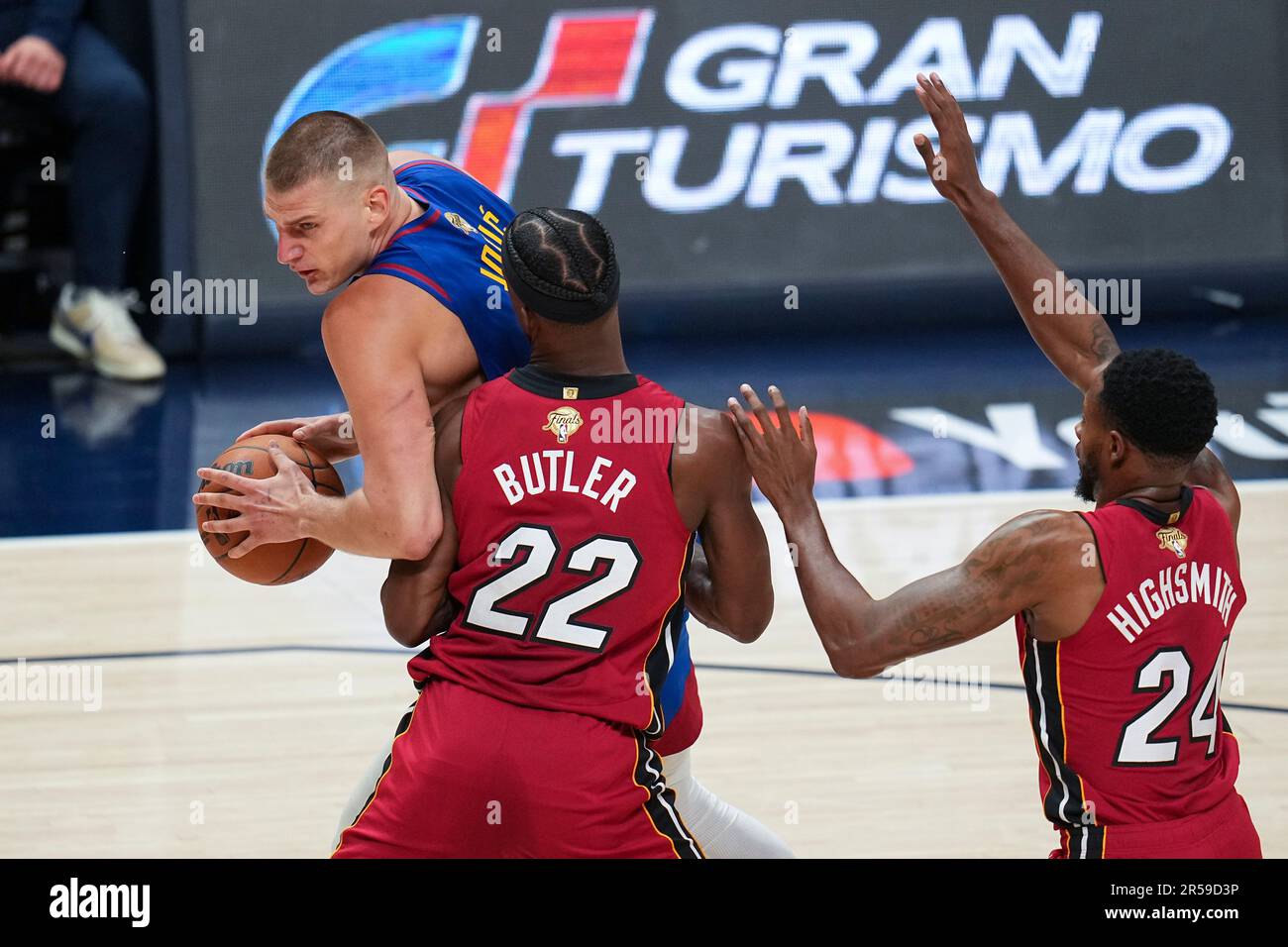 Denver Nuggets center Nikola Jokic, left, tries to get around Miami ...