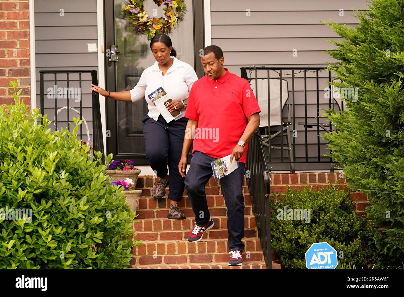 Former Delegate Lashrecse Aird, left, walks from a home with Henrico ...