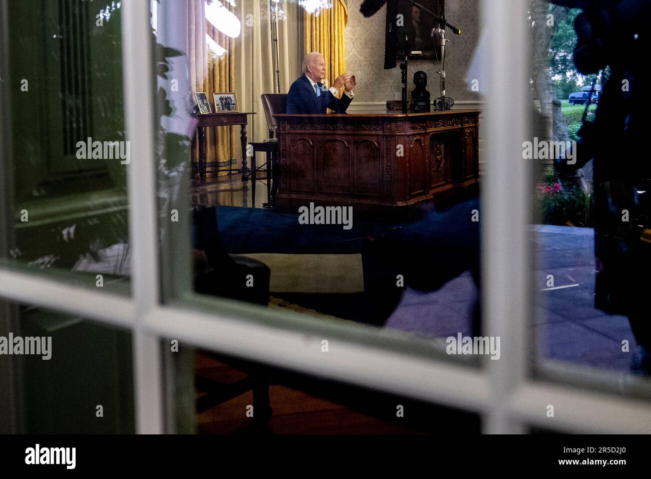 As seen through a window, President Joe Biden addresses the nation on ...
