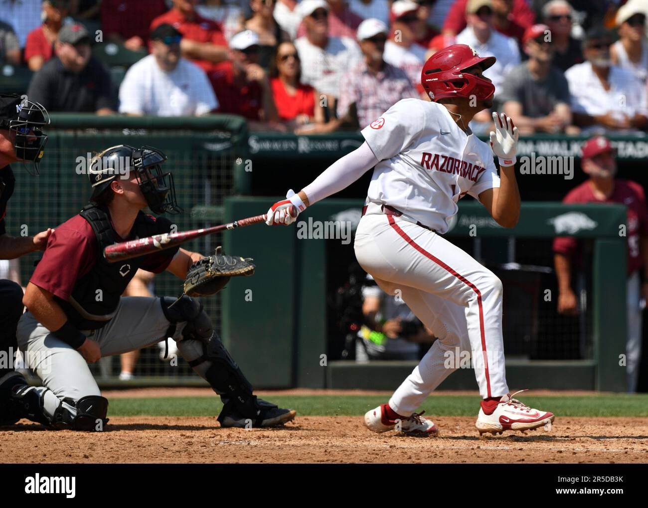 Arkansas' Kendall Diggs follows through on a three-run single against Santa Clara during the ...