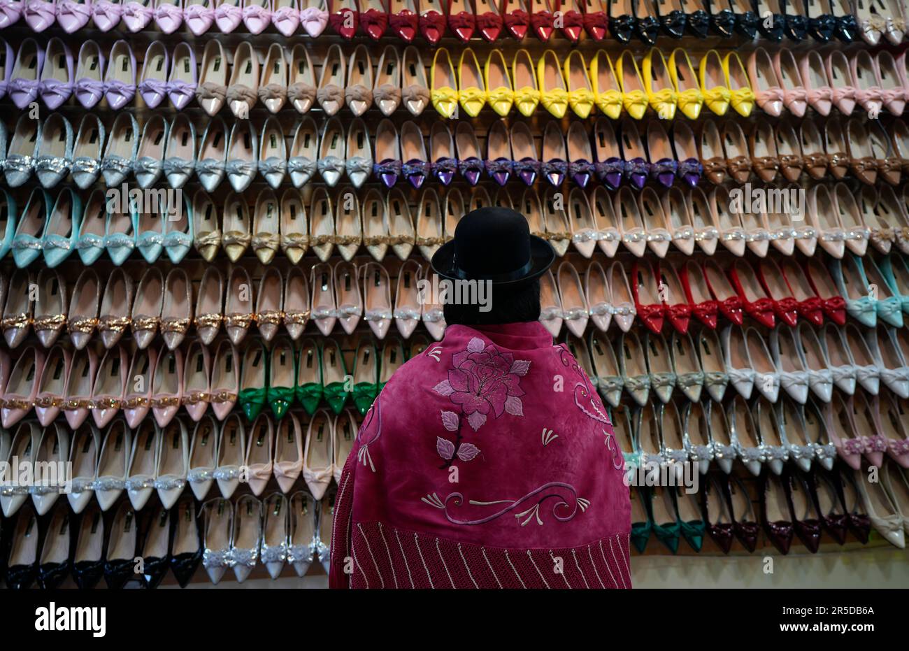 A woman looks at the Chola shoes to be used in the dance of La Morenada ...