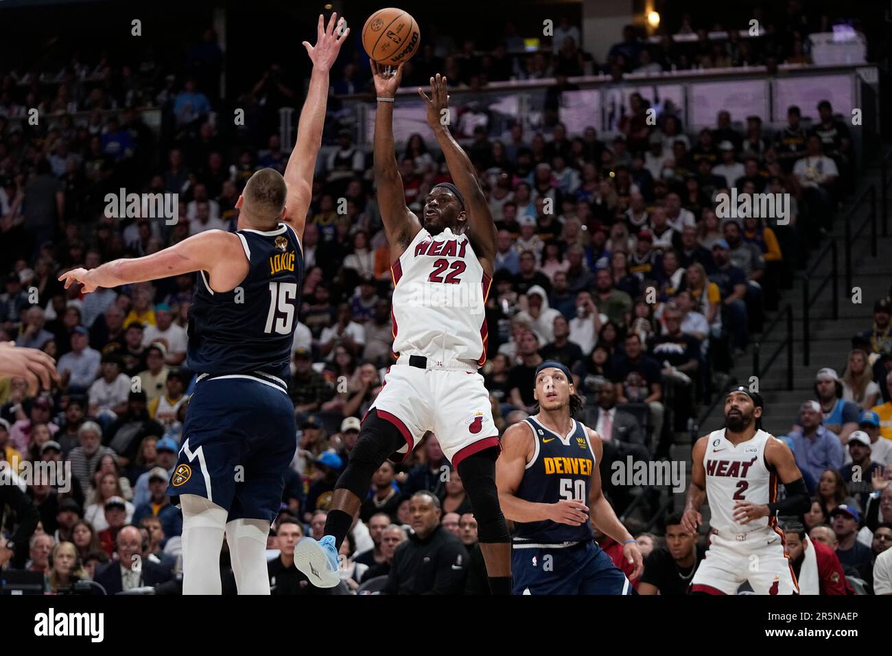 Miami Heat forward Jimmy Butler (22) shoots over Denver Nuggets center ...