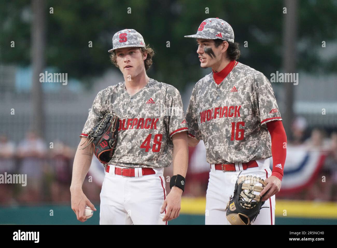 NC State outfielder Eli Serrano III (16) talks with Andrew Shaffner (48 ...