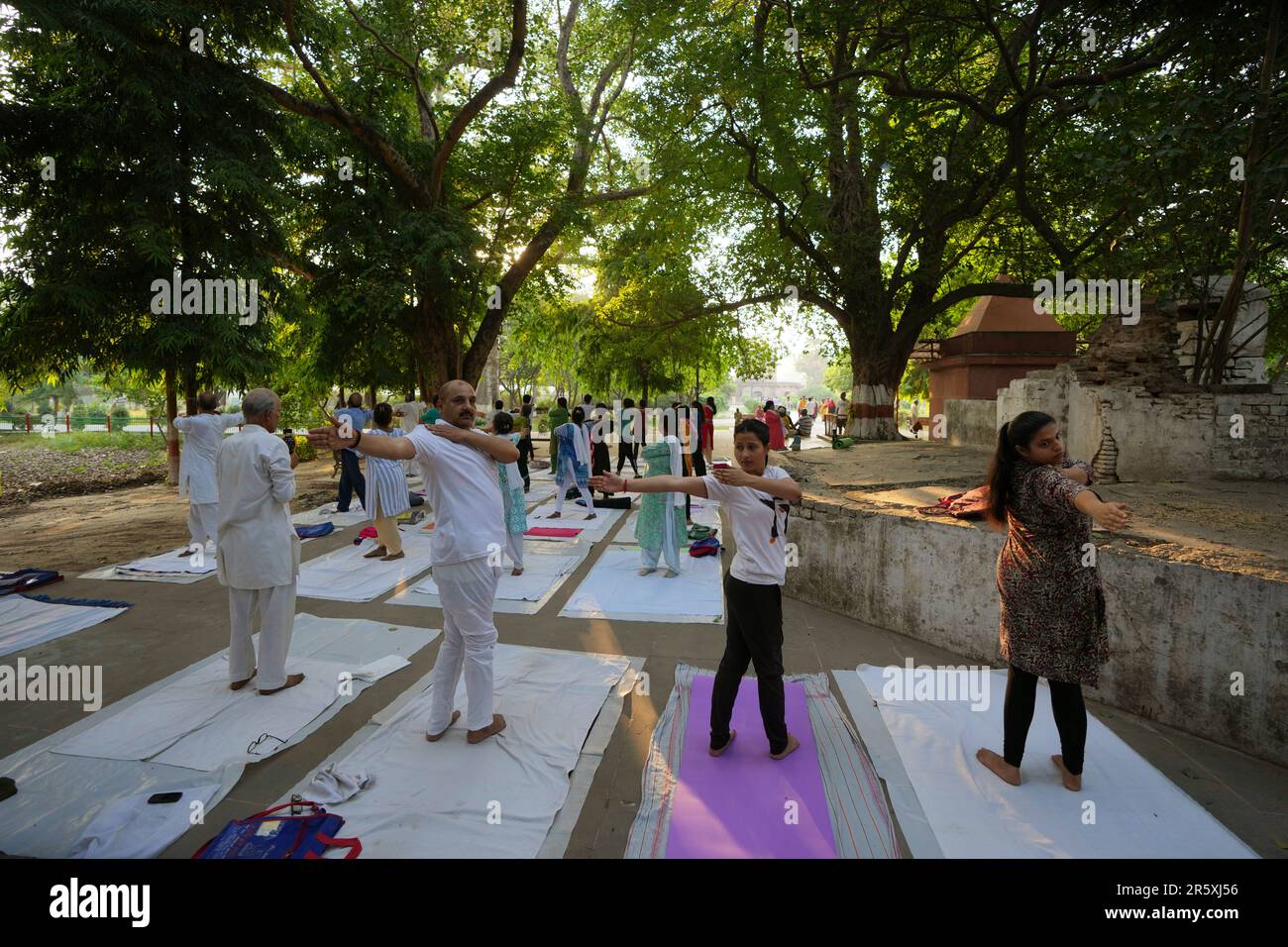 People perform yoga in a group at the Khusro Bagh garden and burial ...