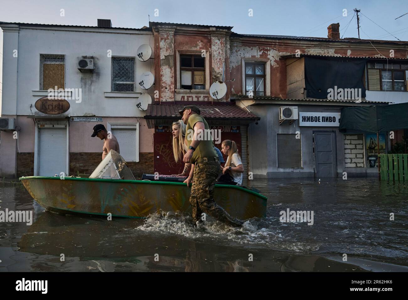 Rescue workers attempt to tow boats carrying residents being evacuated from a flooded ...