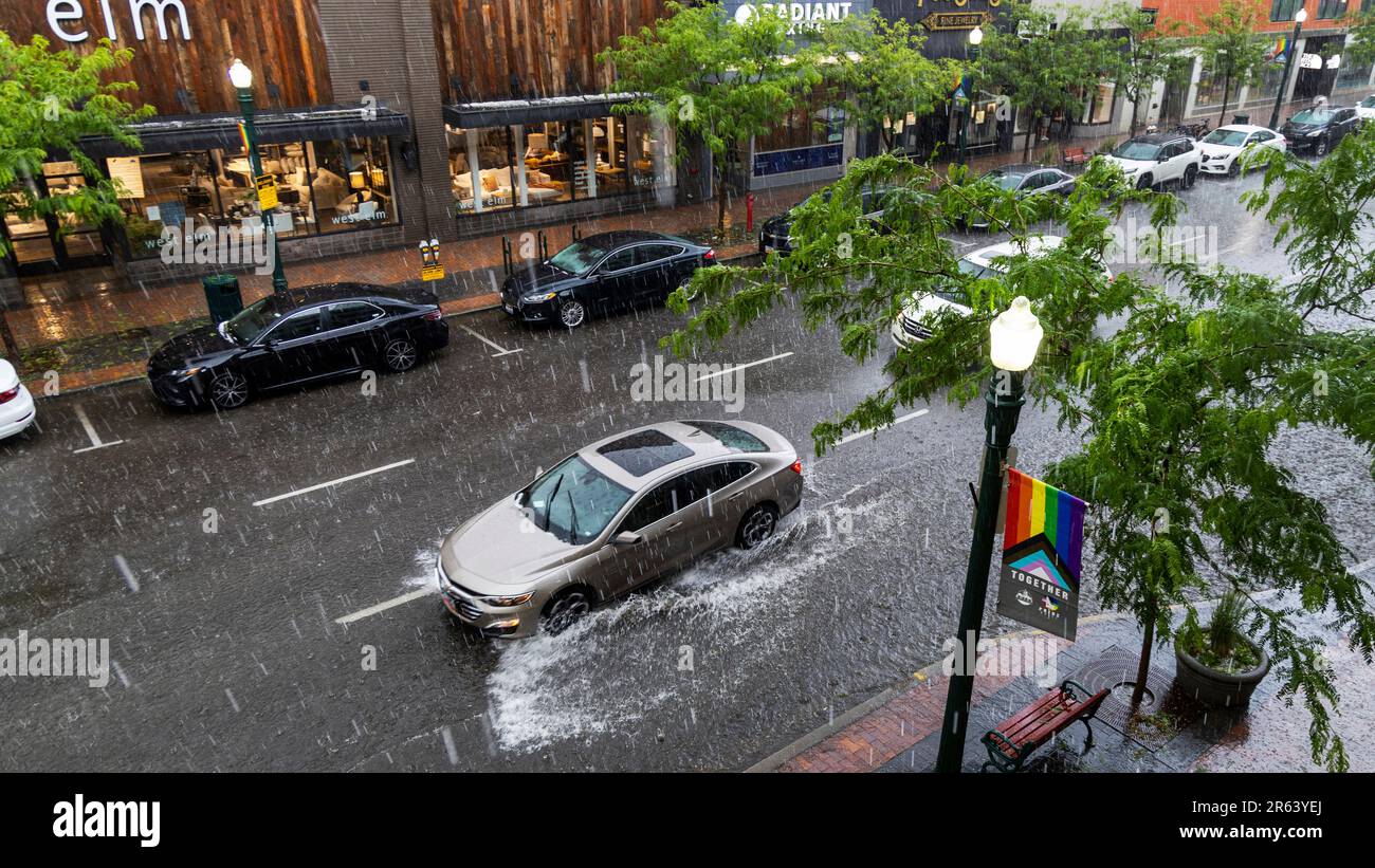 A vehicle splashes through a flooded area of downtown Boise, Idaho ...