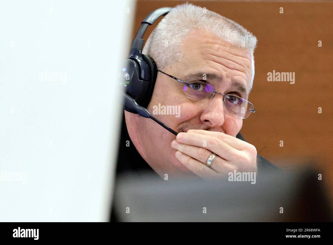 Judge Martin Fein participates in a sidebar discussion via headset ...