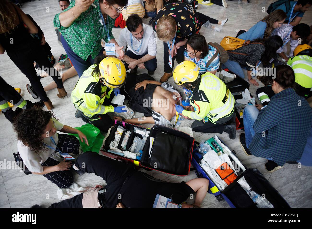 Health workers assist an injured person on a stretcher during a ...