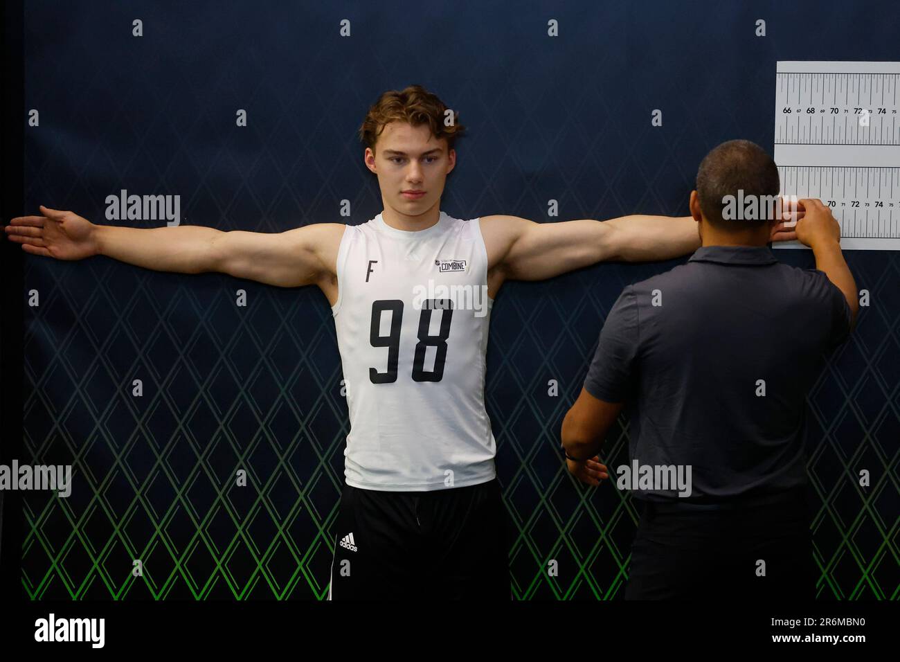 Connor Bedard gets his wingspan measured during the NHL hockey combine ...
