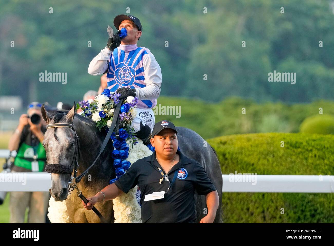 Jockey Javier Castellano kisses a blue rose as he celebrates with ...