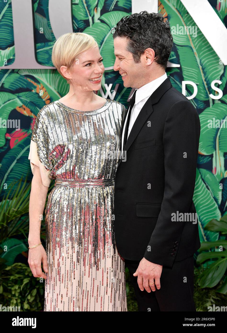 Michelle Williams, left, and Thomas Kail arrive at the 76th annual Tony ...