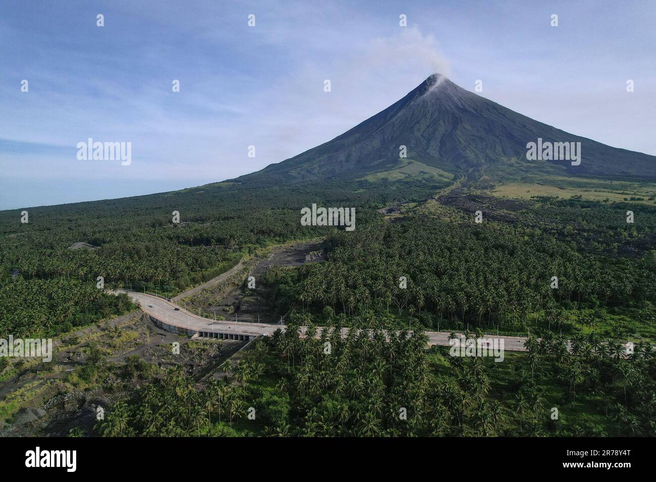 Mayon volcano belches hot emissions down its slope as seen from Daraga ...
