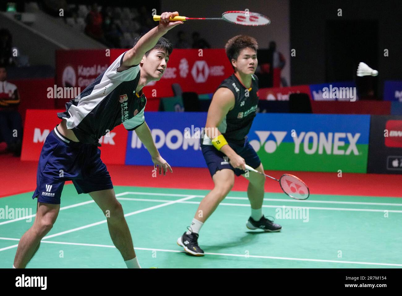 China's Wang Chang, left, with Liang Wei Keng play against Indonesia's ...