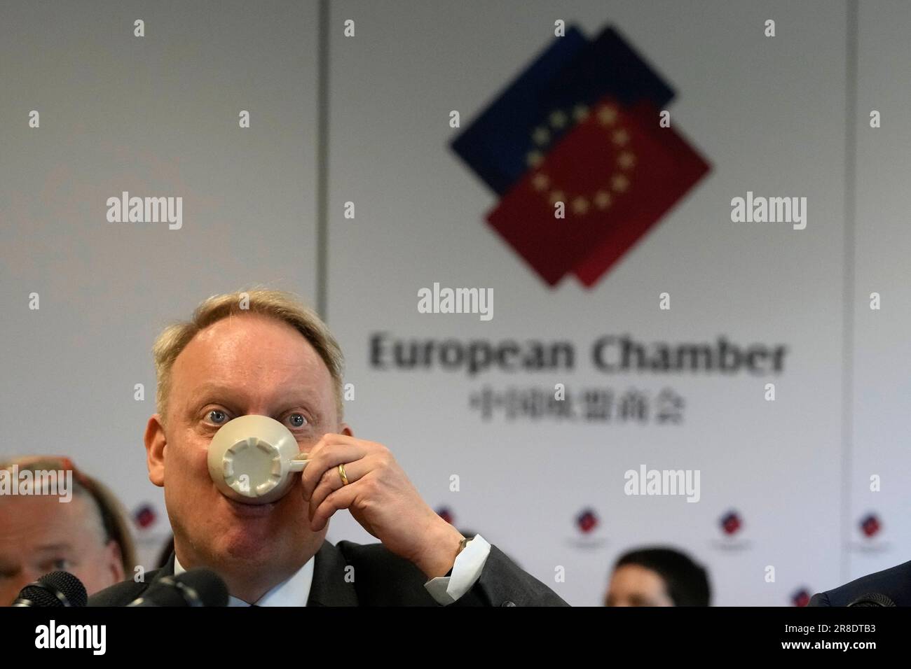 Jens Eskelund, President, European Chamber drinks from a cup at the ...