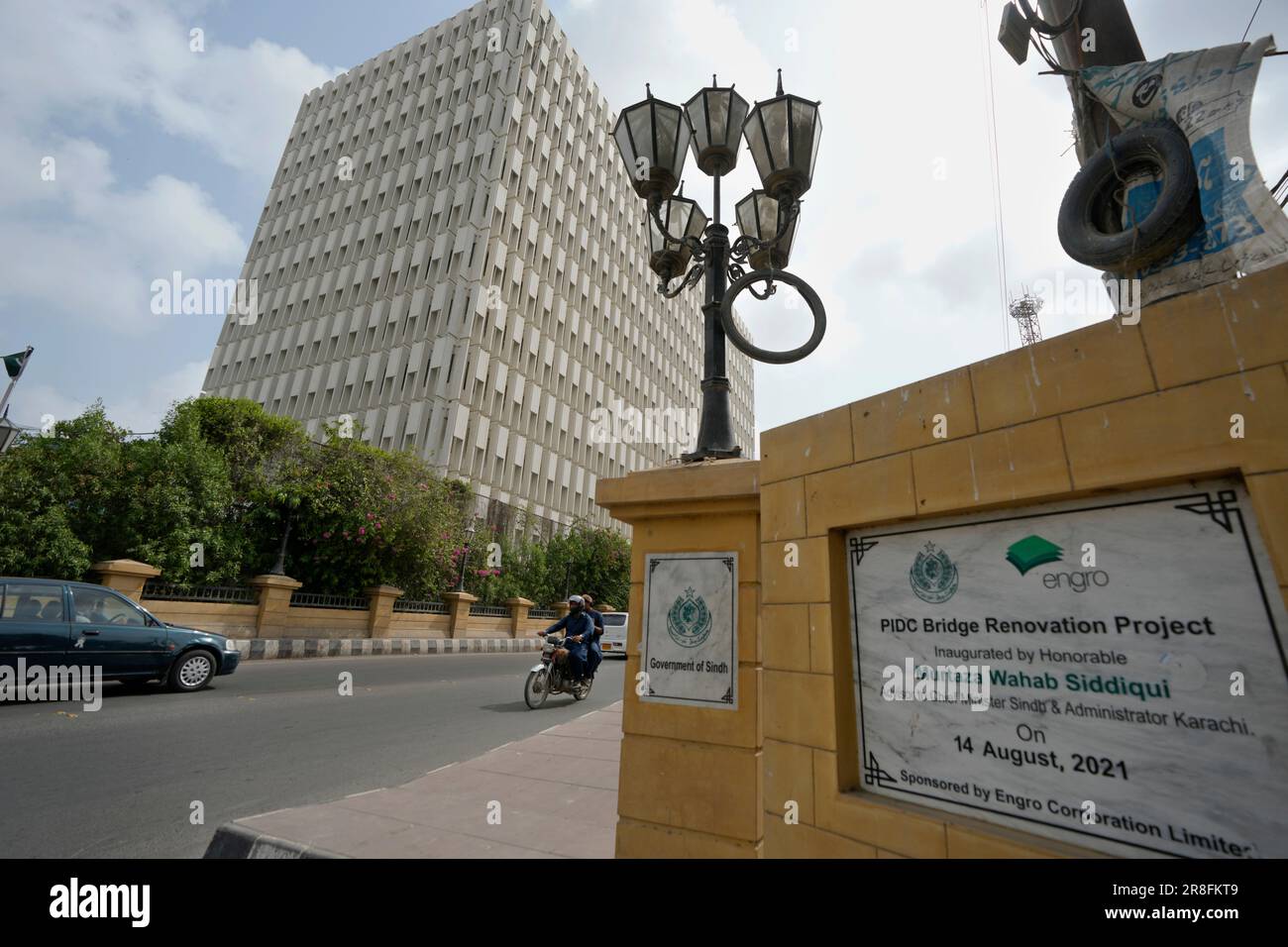 A motorcyclist rides past a head office building of Dawood Hercules ...