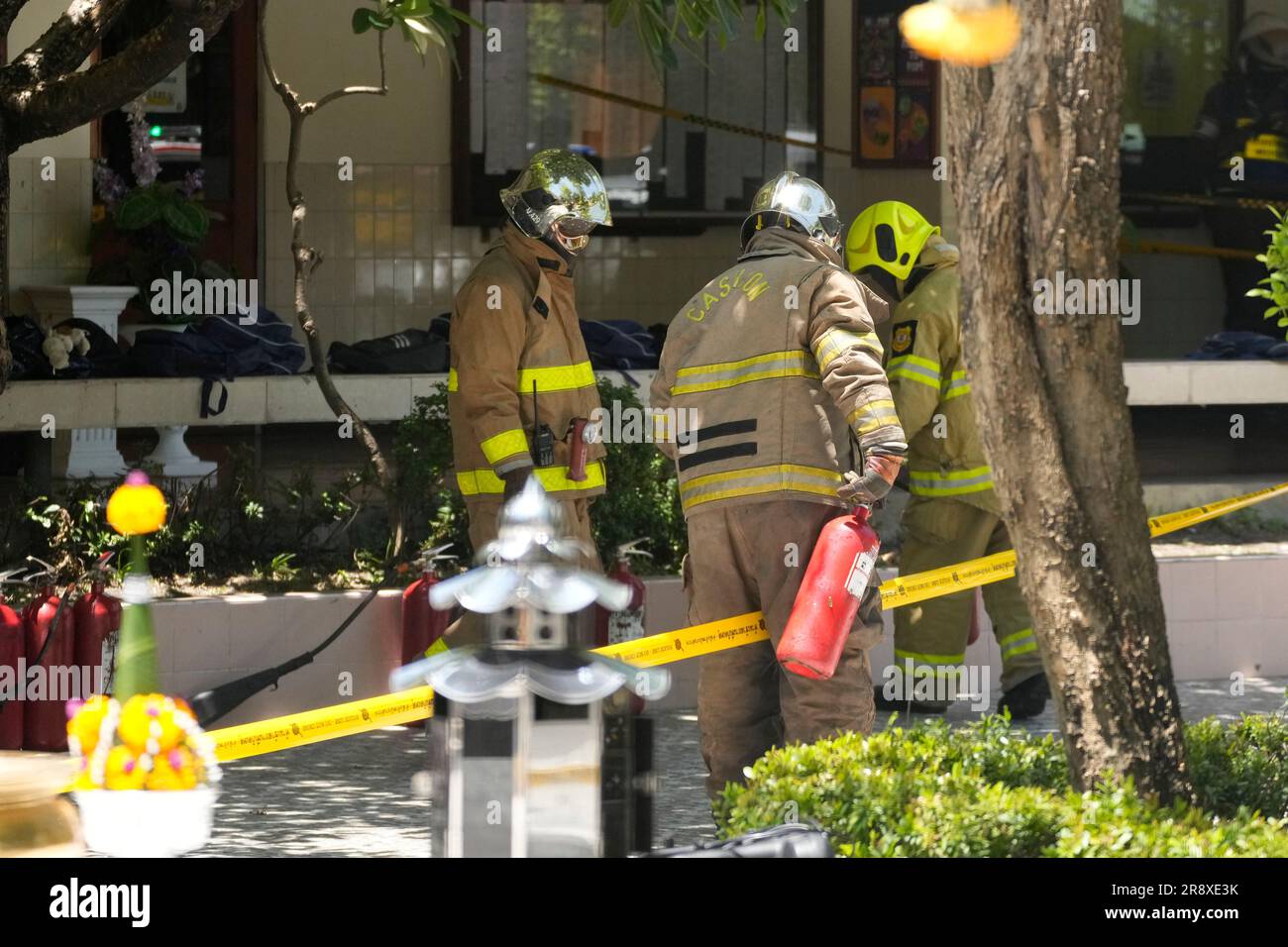 Firefighters investigate an explosion site at a school in Bangkok ...