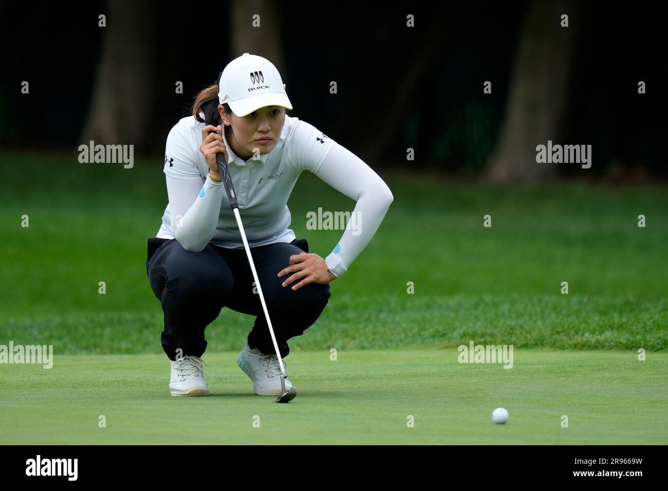 Xiyu Lin, of China, lines up her putt on the second hole during the ...